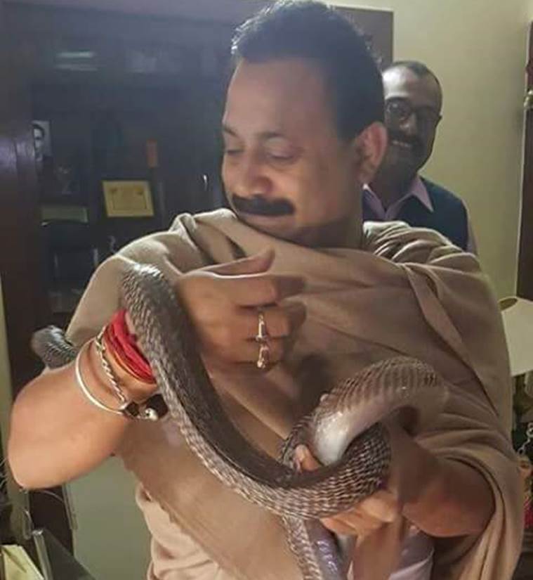 Bihar minister under fire as photos with snakes go viral | India News ...