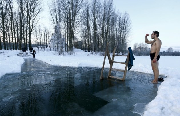 People plunge into ice cold water to celebrate Epiphany around the ...