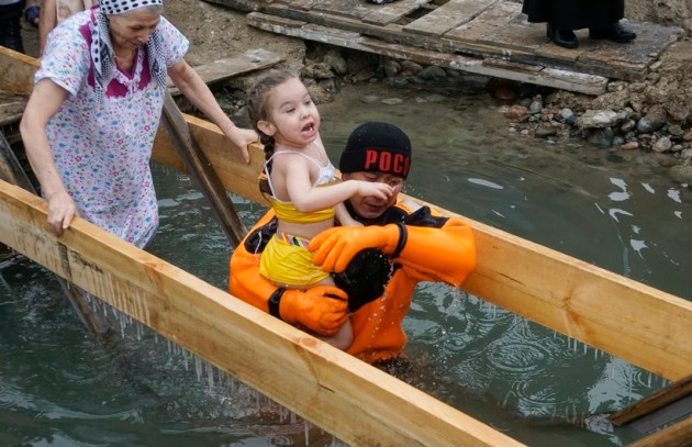 People plunge into ice cold water to celebrate Epiphany around the ...