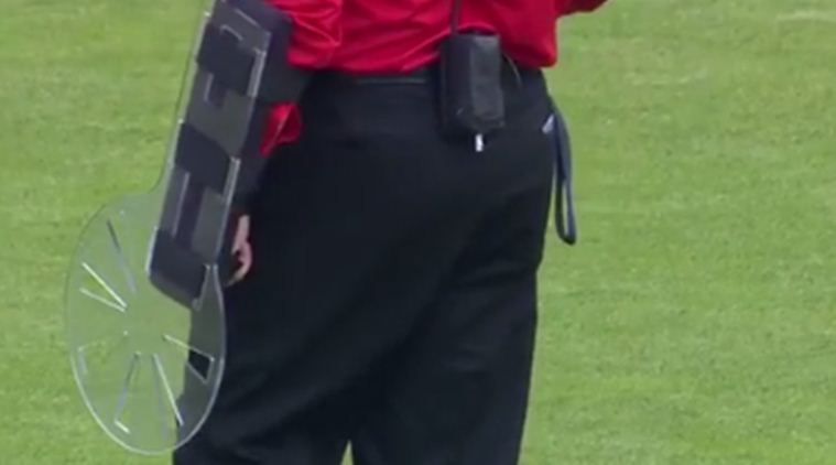 Cricket umpire dons bizarre protective shield to guard himself ...