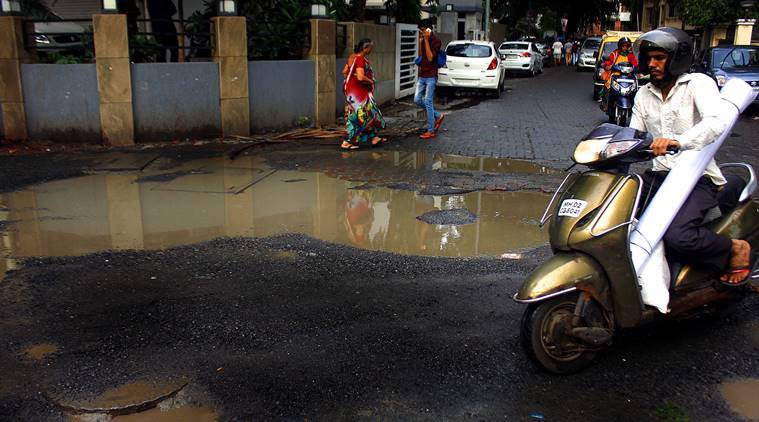 Potholes appear on Mumbai road two months after repair, corporator says ...