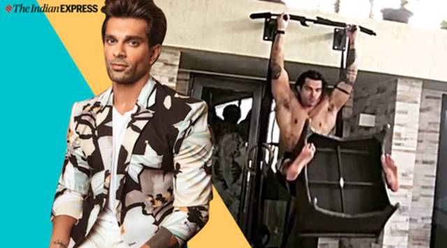 Karan Singh Grover lifts a stool with his feet while doing hanging leg ...