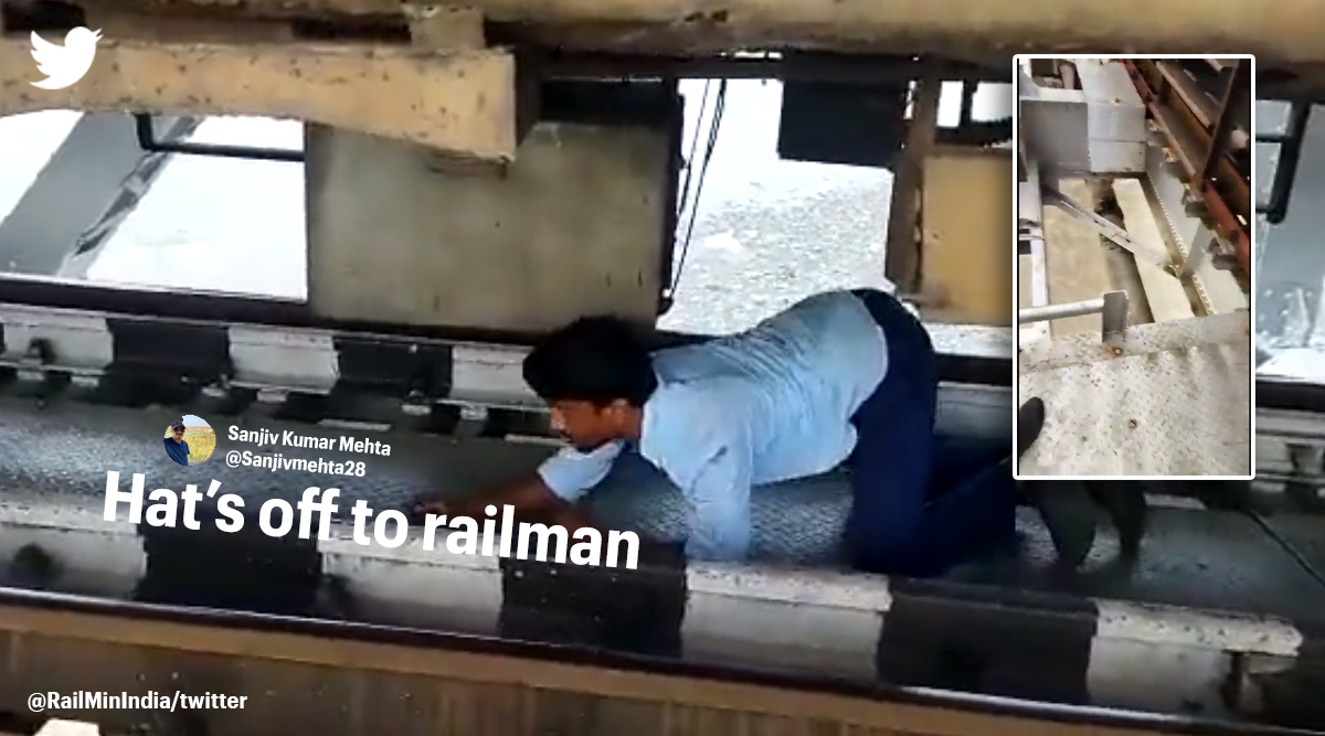 Railway employee crawls under train stuck on bridge to fix air-leakage ...