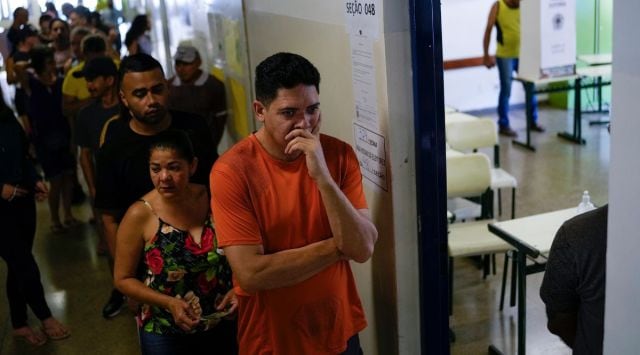 Deeply divided, Brazilians abroad join long queues to vote in tense ...