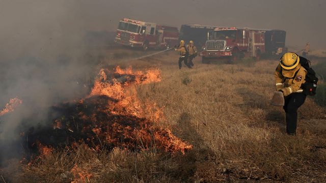 California firefighters battle wind-driven wildfire east of San ...