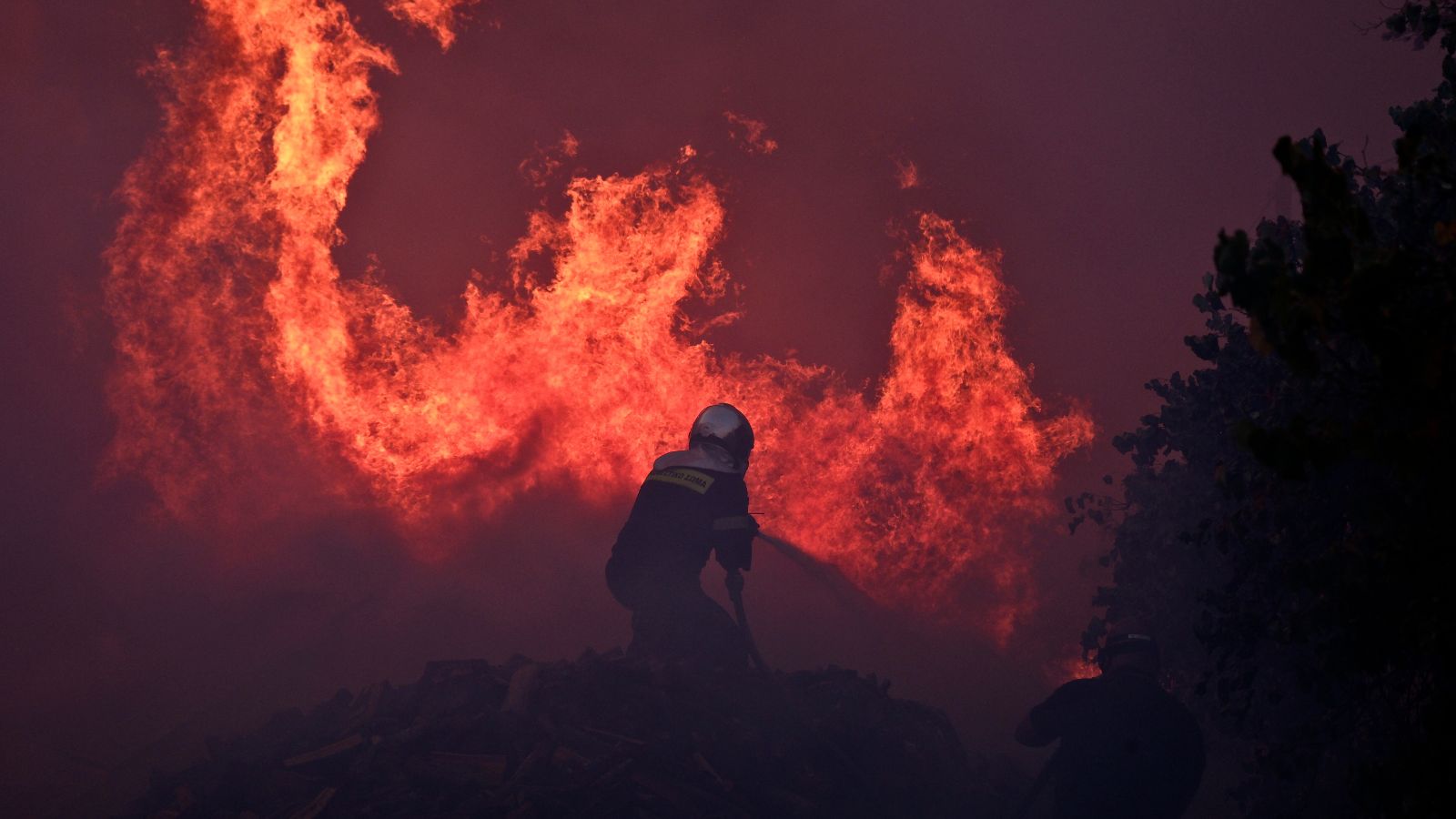 Wildfire fanned by gales menaces Athens suburbs as residents flee ...