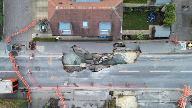 Watch: Large sinkhole swallows gardens in UK village, forces ...
