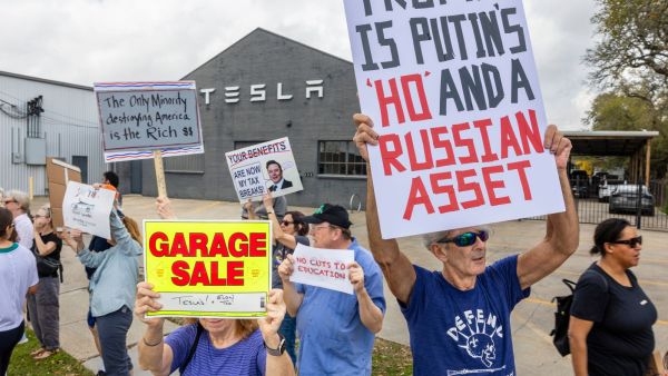 In pictures: Hundreds protest outside Tesla showrooms over Musk’s role ...