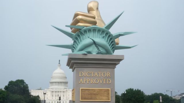 ‘Dictator Approved’: a golden thumbs-up crushing Statue of Liberty ...