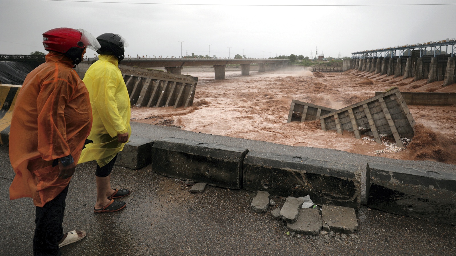Two killed and scores marooned as rain triggers flash floods ...