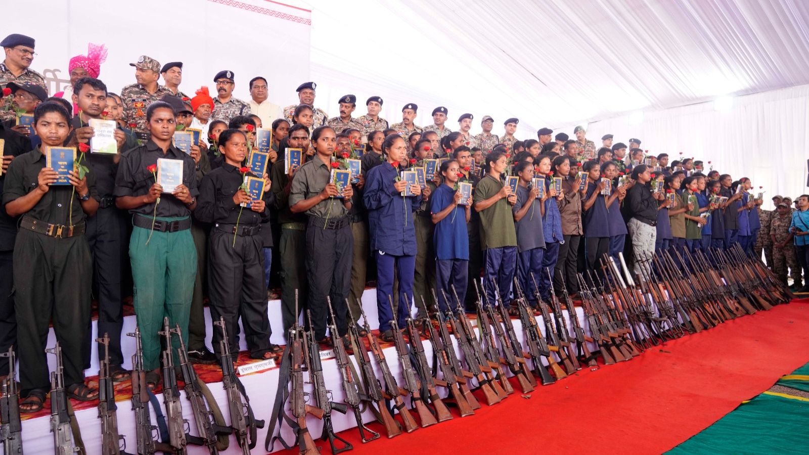 Roses, the Constitution, and posing for cameras: As 210 Naxals lay down ...